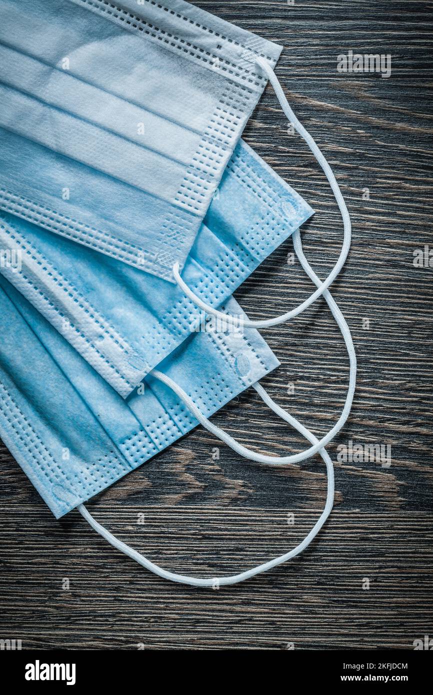 Blue disposable face masks on vintage wooden board Stock Photo - Alamy