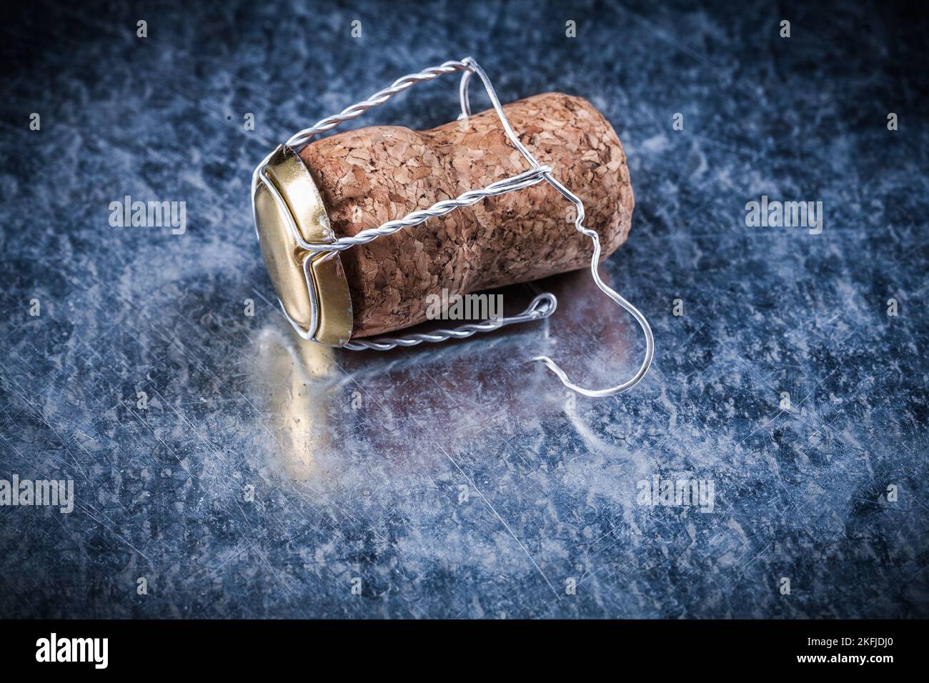 Champagne cork twisted wire on scratched metallic background alcohol ...