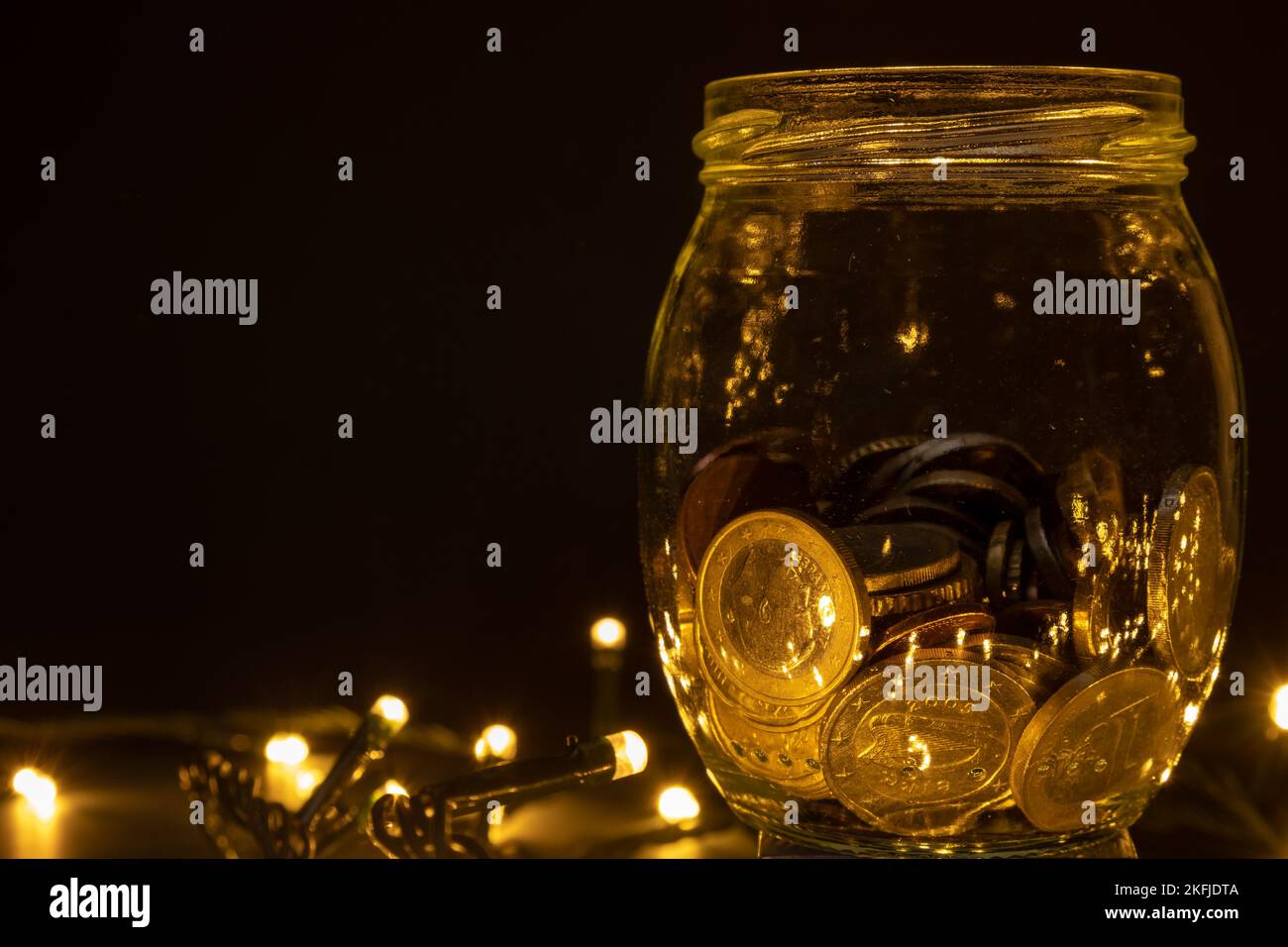 Glass jar with euro coins on a dark background with led lights. Euro ...