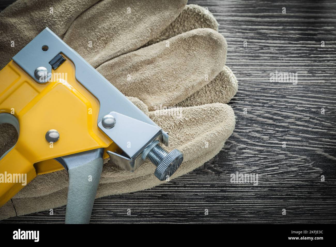 Construction stapler pair of safety gloves Stock Photo - Alamy