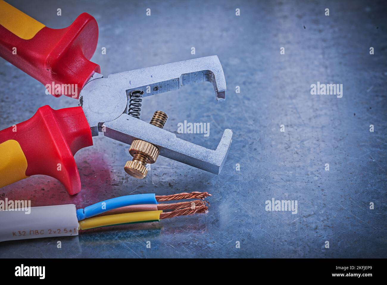 Insulated strippers electrical wires on metallic background directly ...