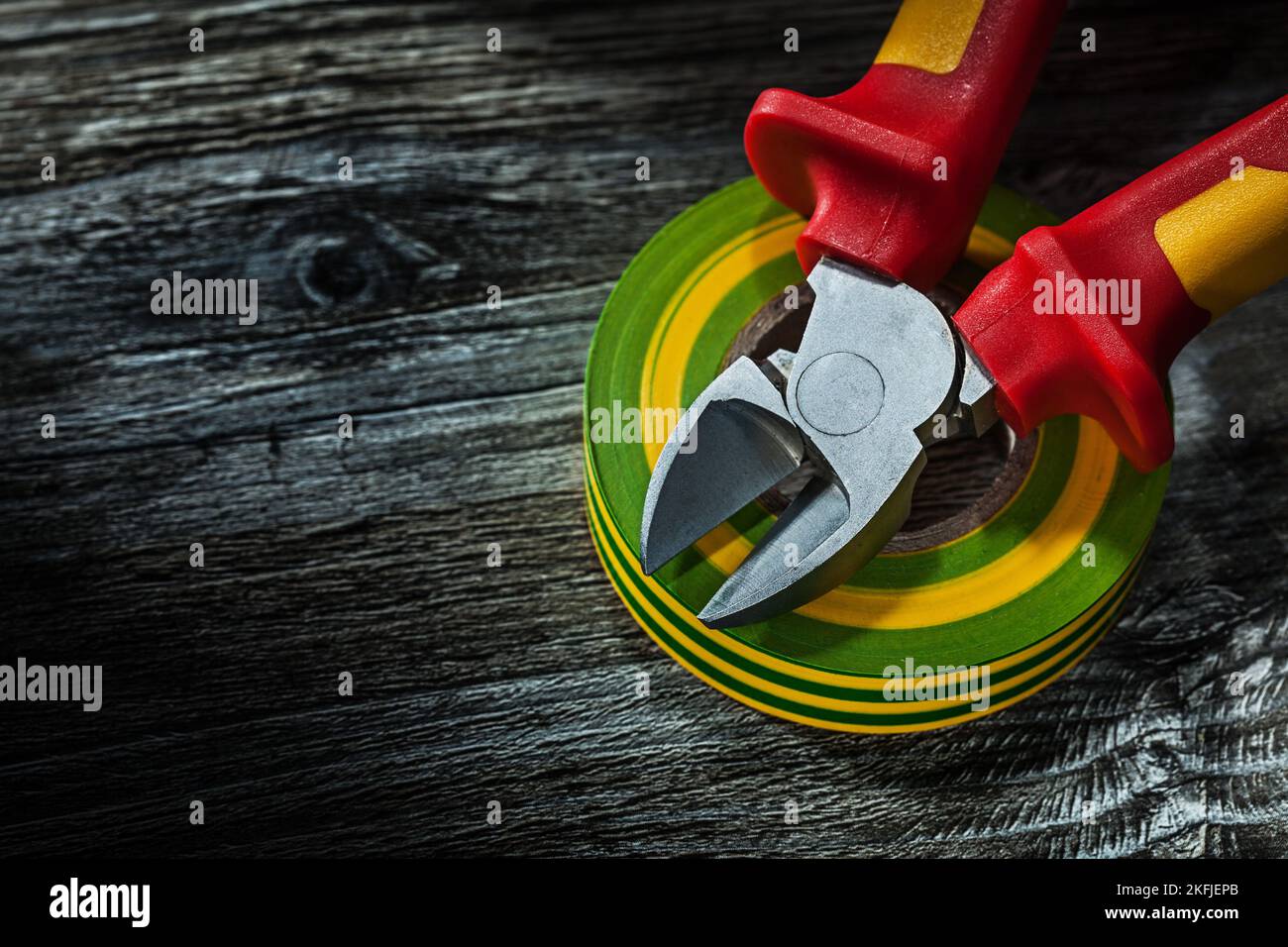 Insulation tape cutting pliers on wooden board Stock Photo - Alamy