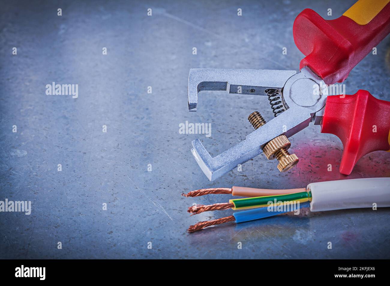 Insulated strippers electric wires on metallic background horizontal ...