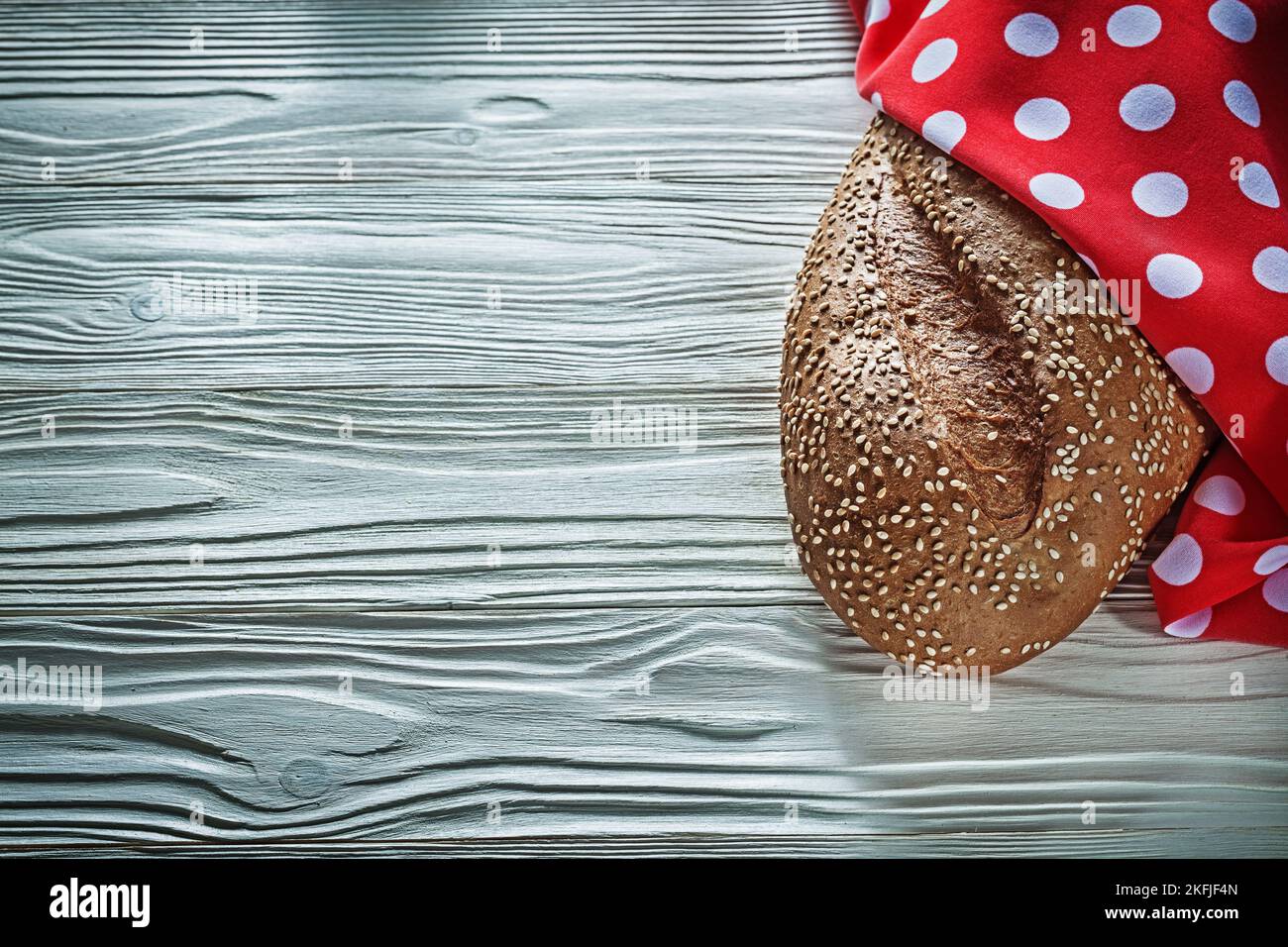 Loaf of bread polka-dot napkin on vintage wooden board Stock Photo - Alamy