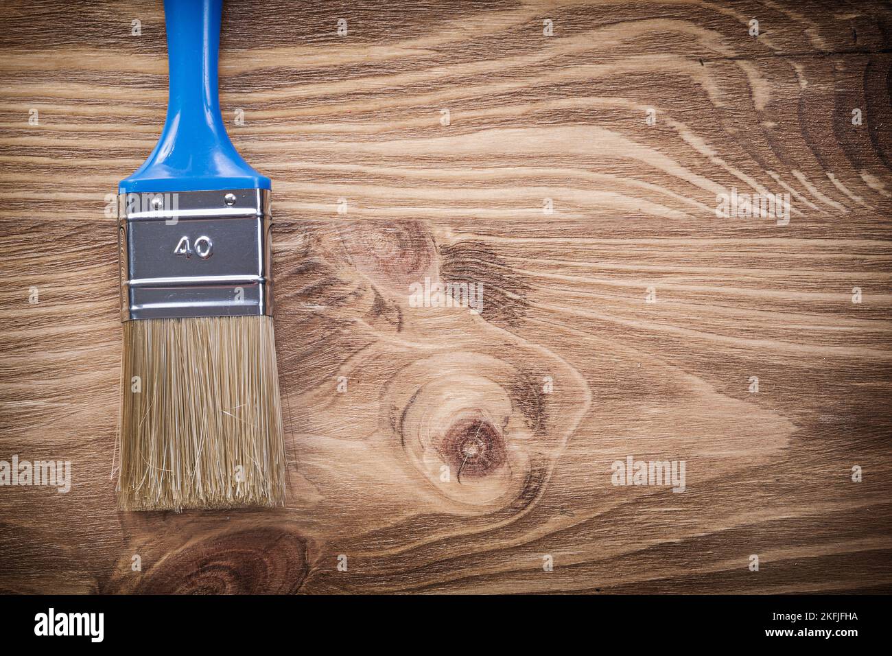 Paintbrush on wood board top view construction concept Stock Photo - Alamy