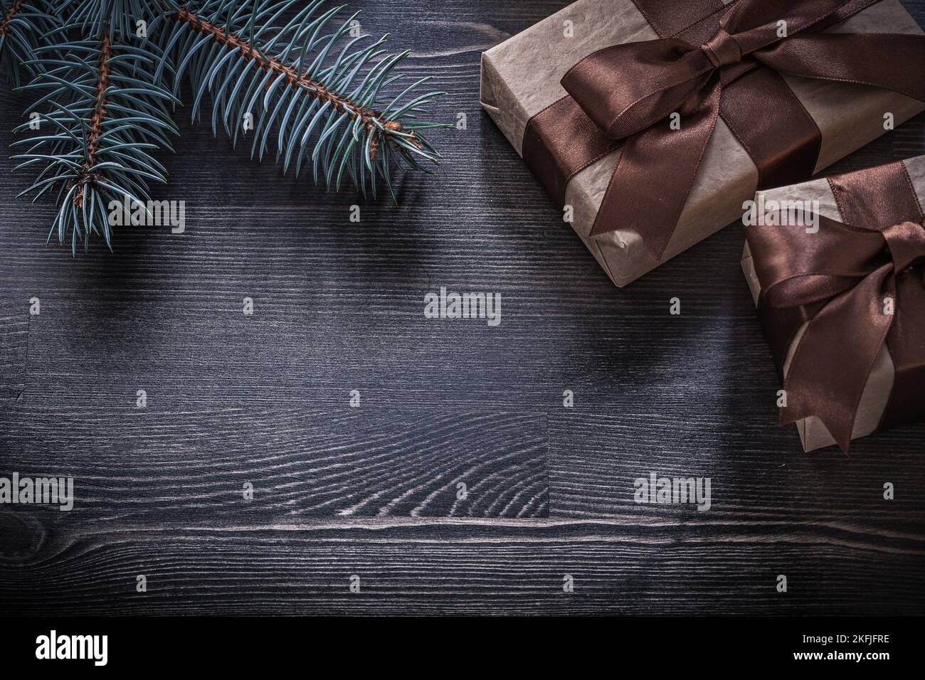 Pine tree branch giftboxes on wooden board holiday concept Stock Photo ...