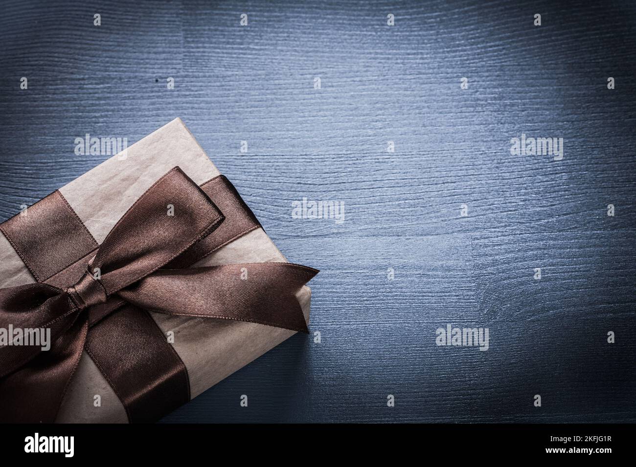 Present box with bow on vintage wooden board holiday concept Stock ...