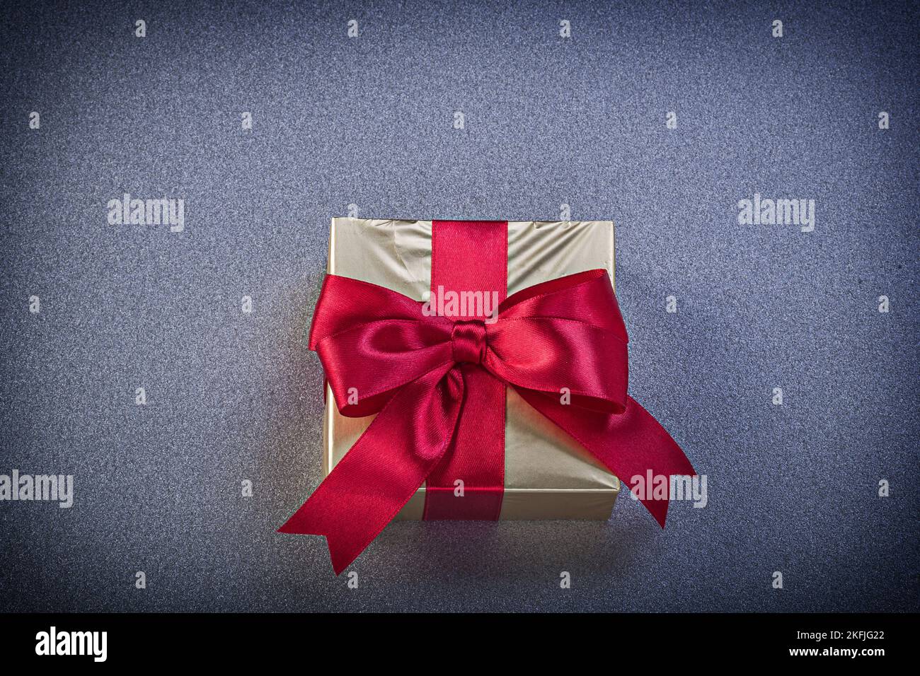 Present box with red ribbon on grey background holidays concept Stock ...