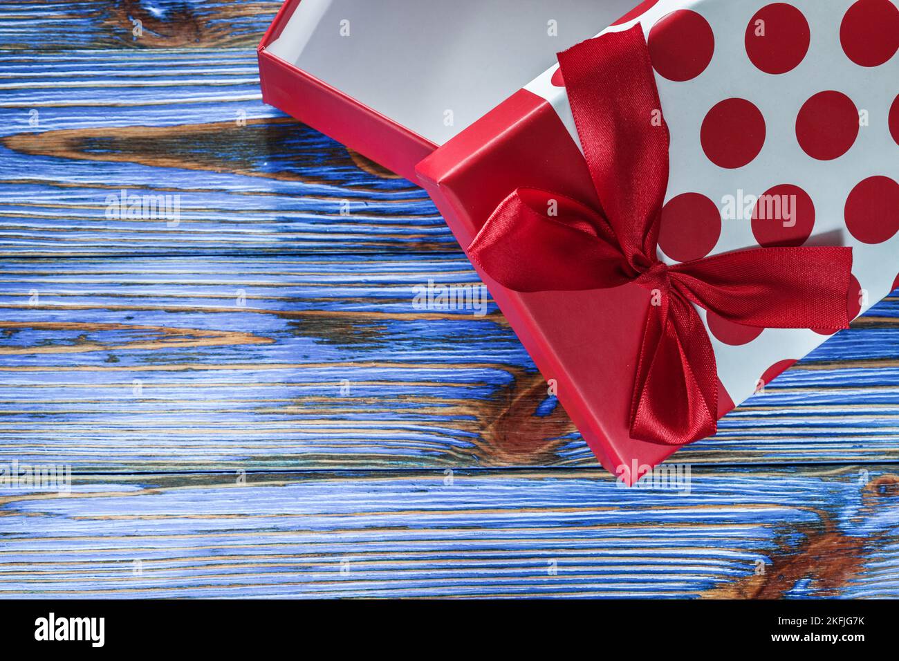 Red packed gift box on vintage wooden board Stock Photo - Alamy