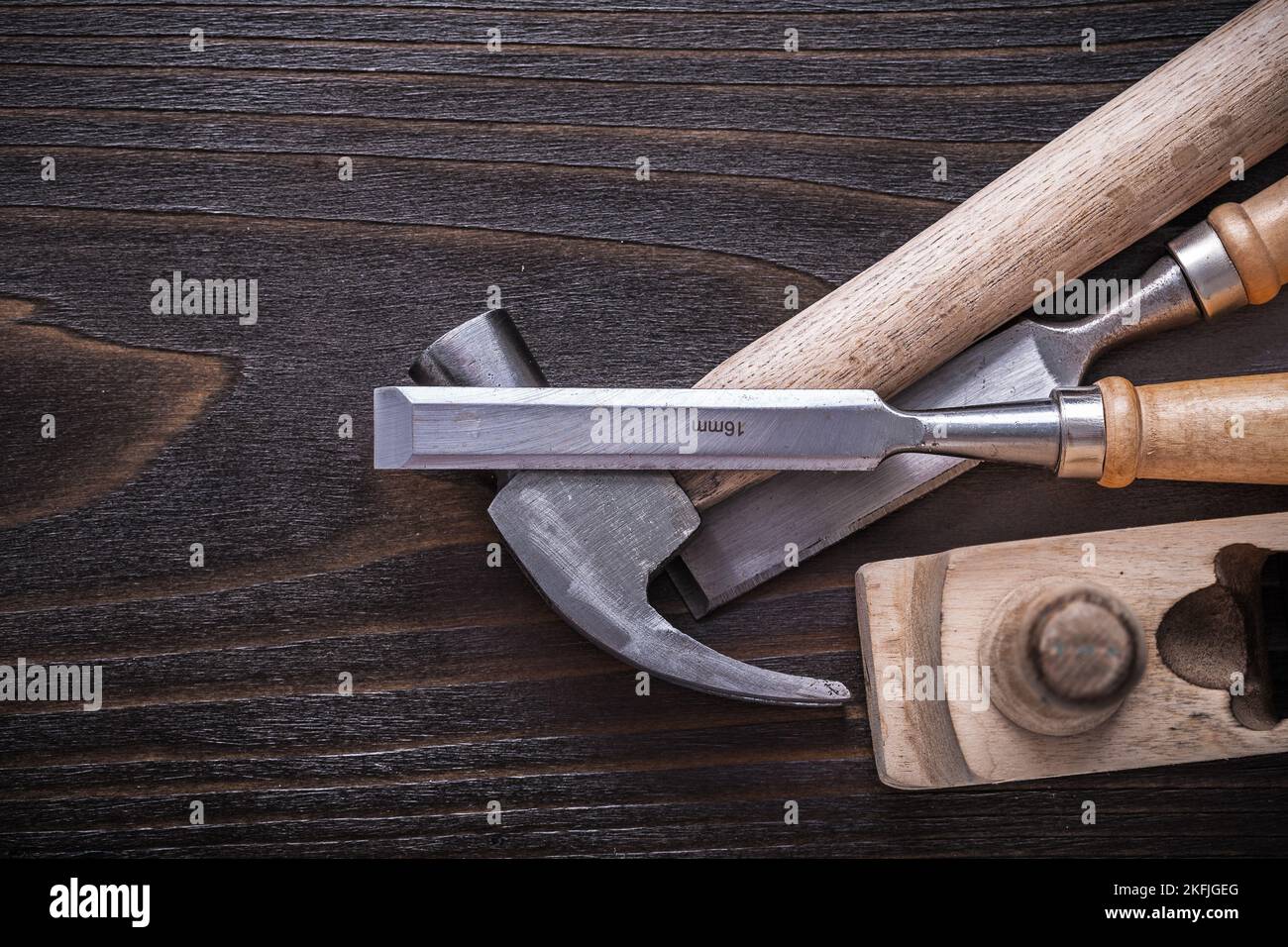 Set of claw hammer planer and firmer chisels on vintage wooden board ...