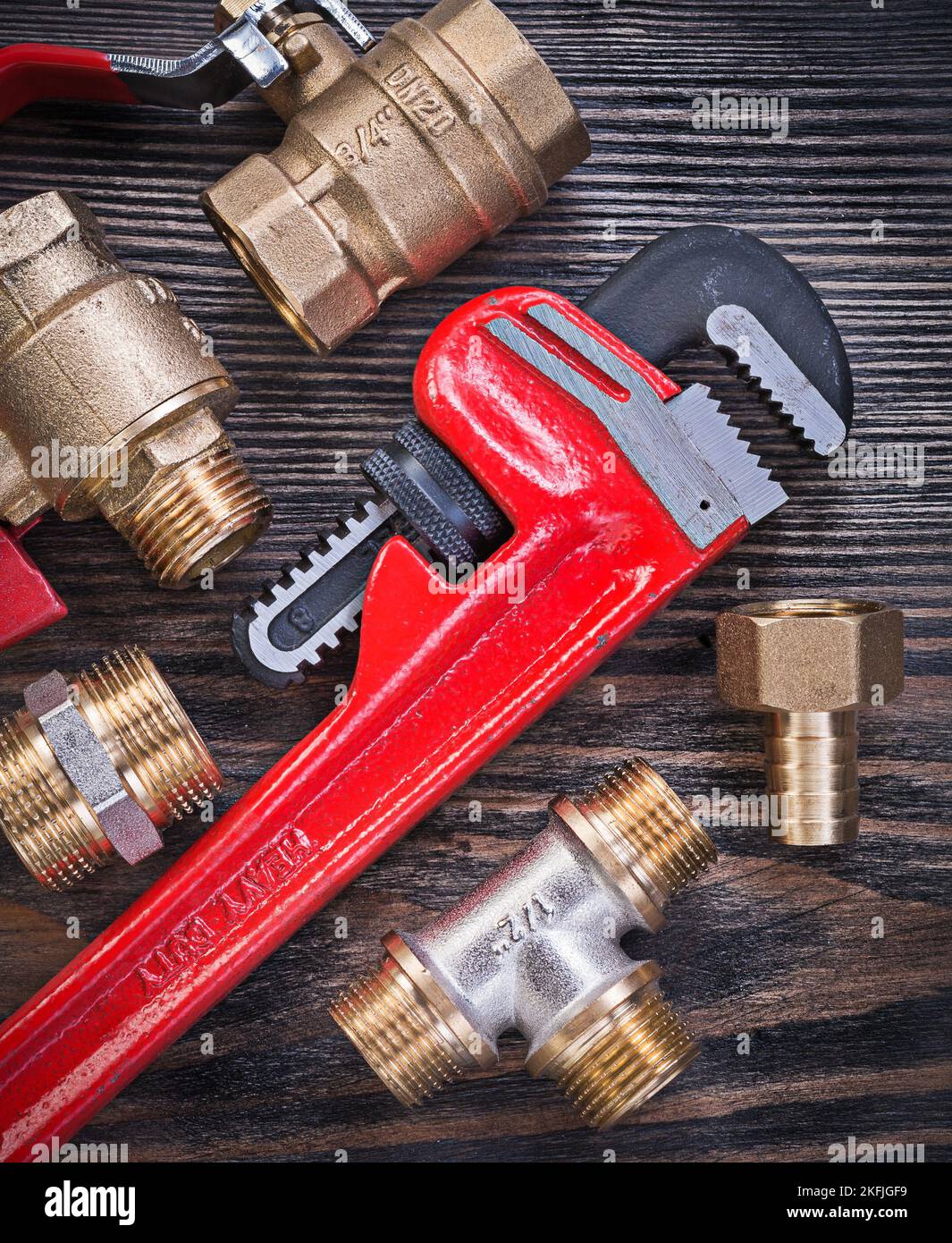 Set of monkey wrench brass connectors water valve on wooden board ...