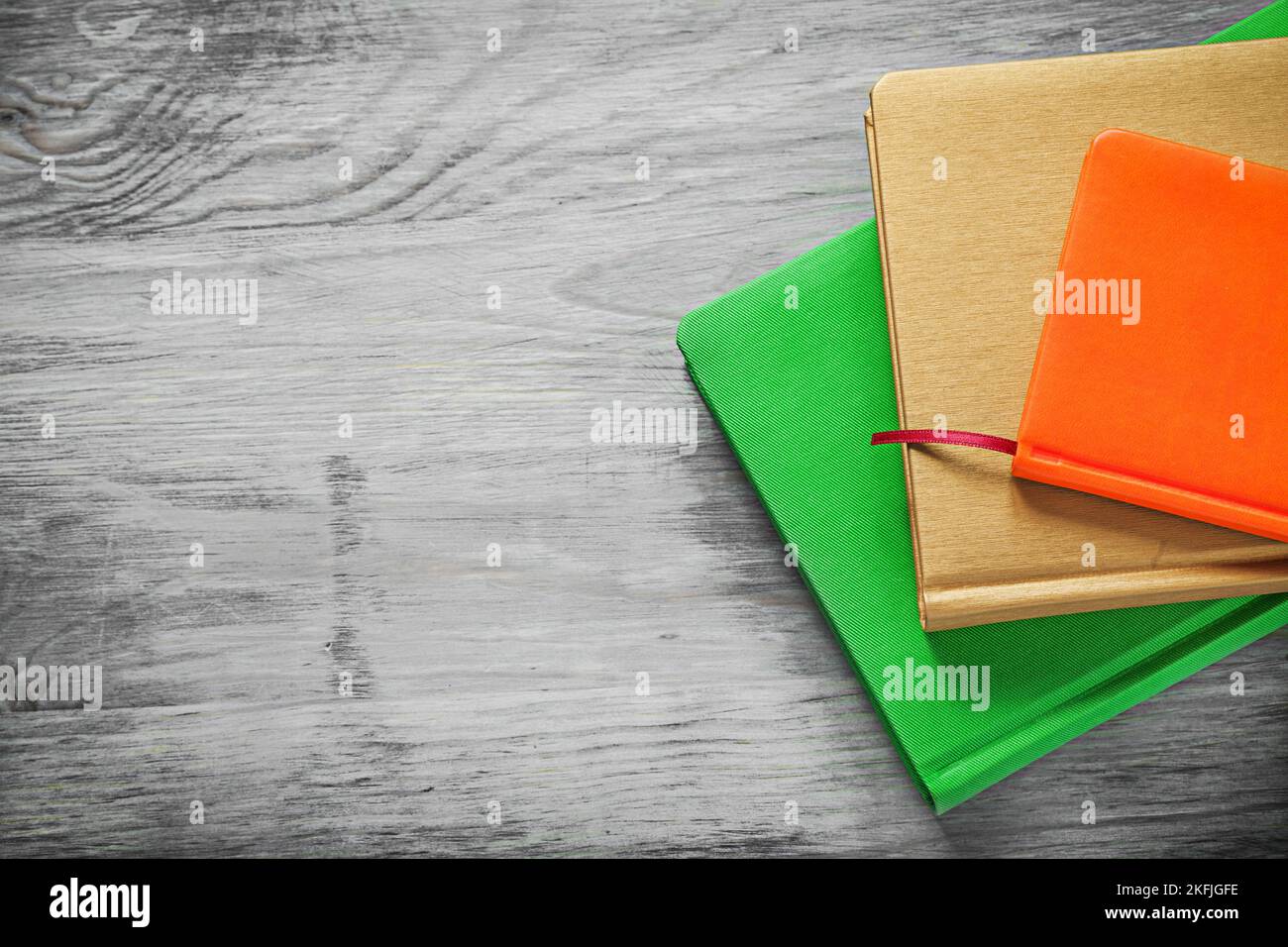 Set of notepads on wooden board office concept Stock Photo - Alamy