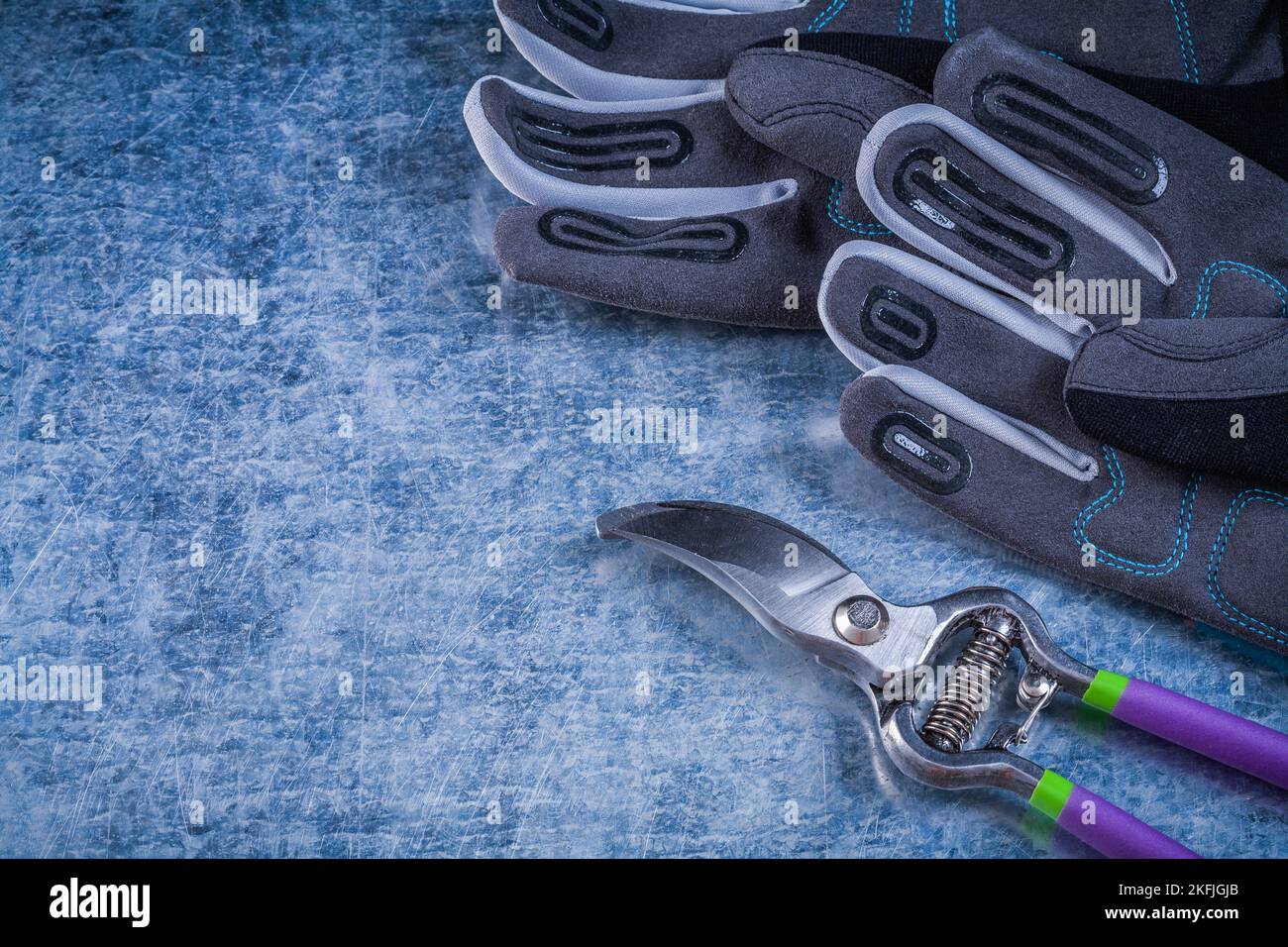 Sharp garden pruner safety gloves on metallic background agriculture ...