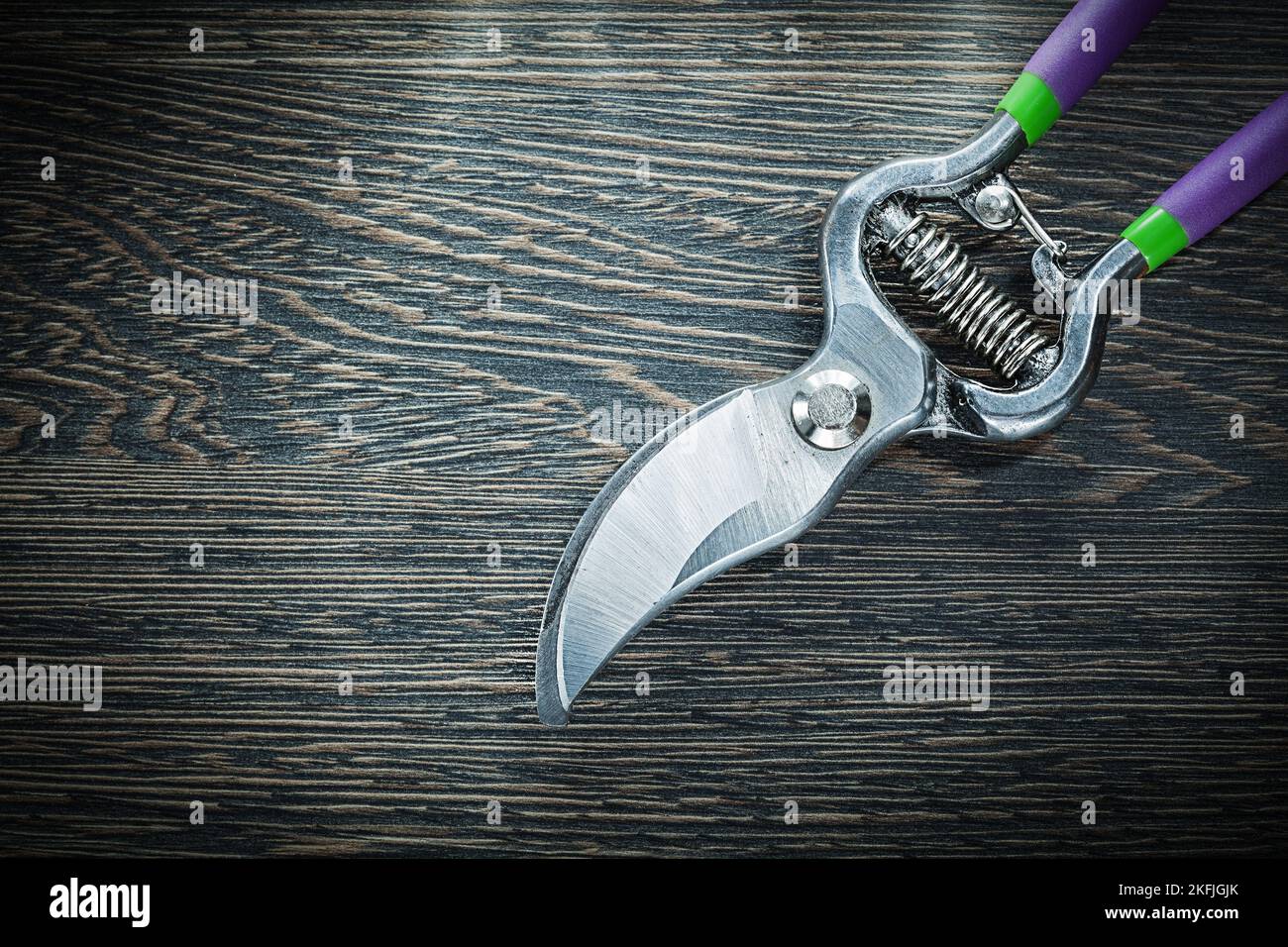 Sharp garden pruner on wooden board Stock Photo - Alamy
