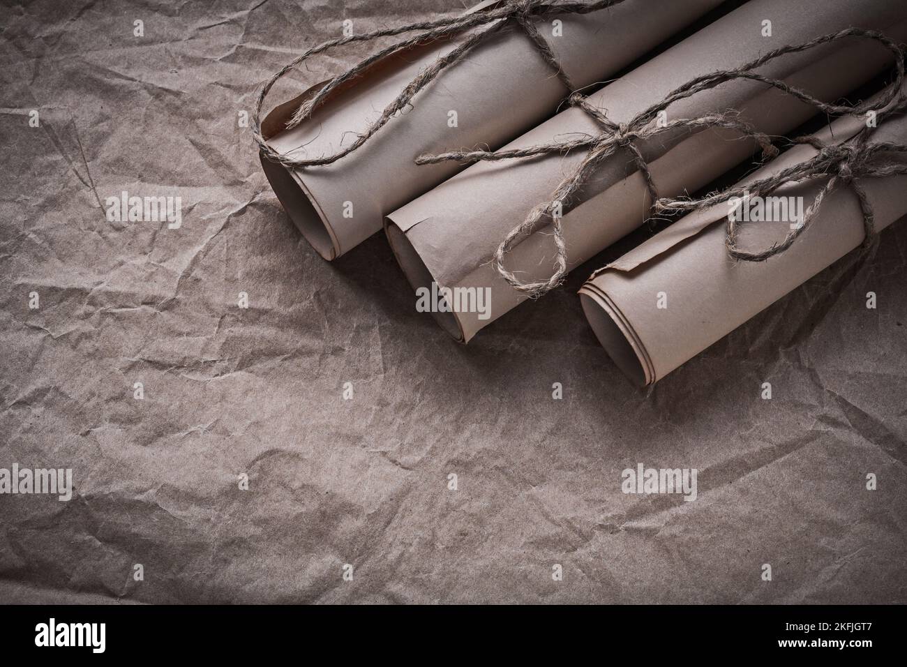 Stack of vintage paper rolls on crumpled wrapping sheet Stock Photo - Alamy