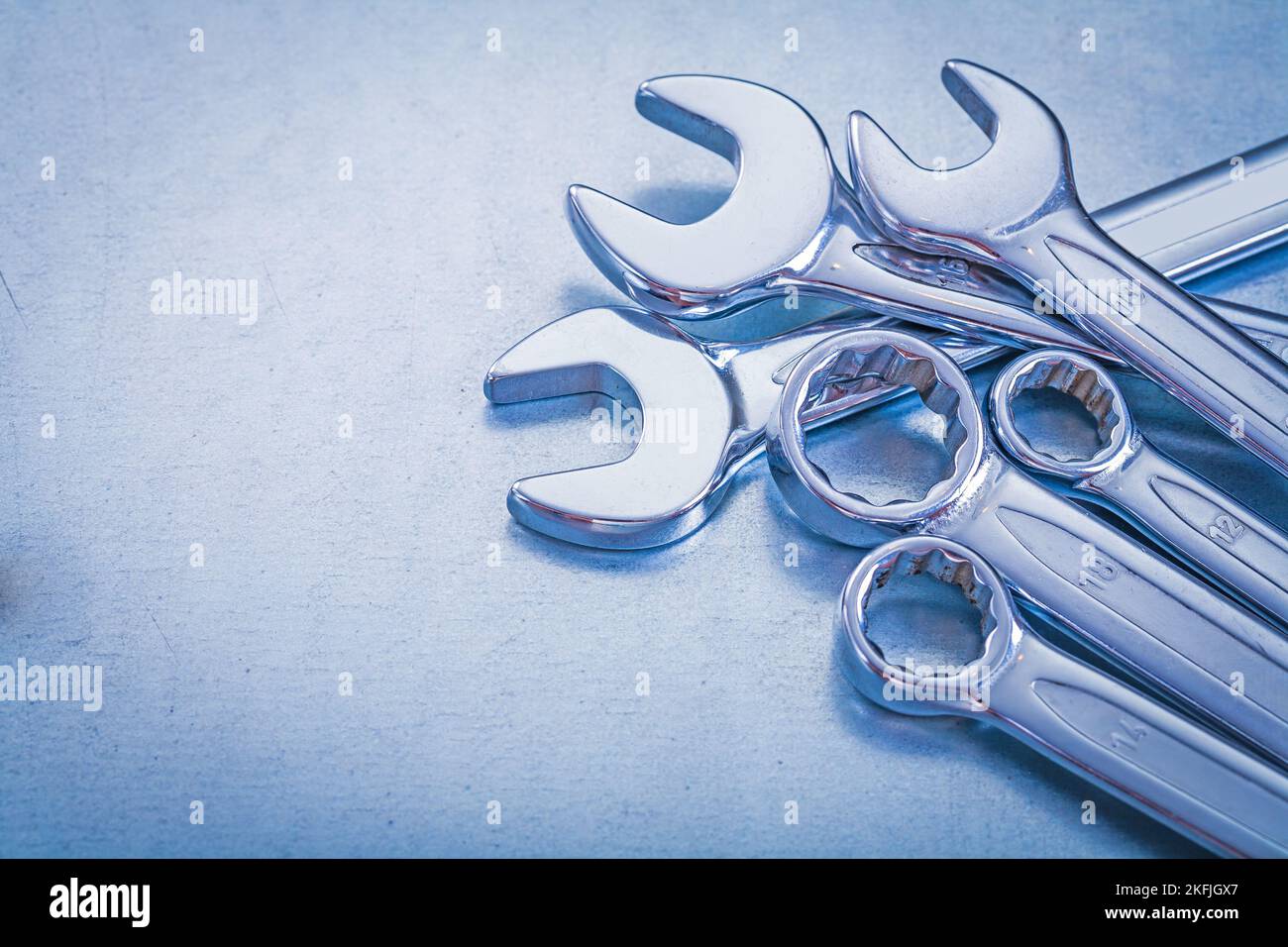 Steel open-end wrenches and flat spanners on metallic background ...