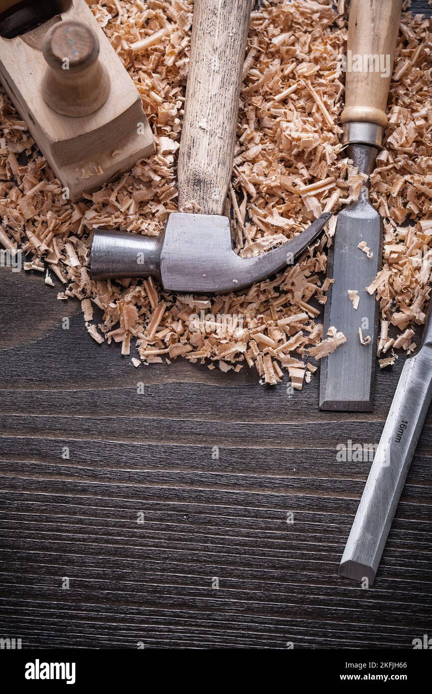 Vertical view of claw hammer chisels wooden shaving plane and planning ...