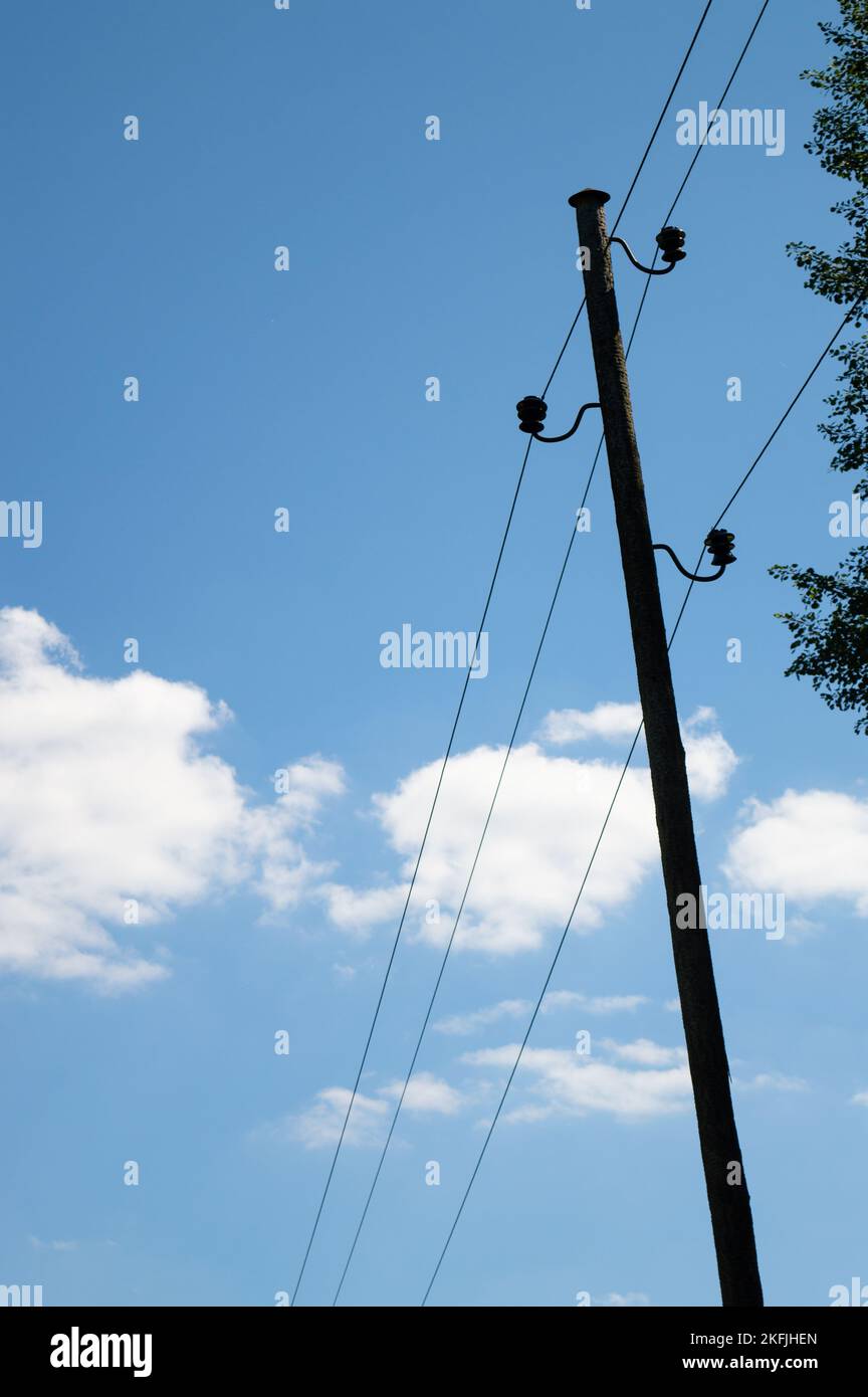 Communications pole with cables and holders on blue sky background ...