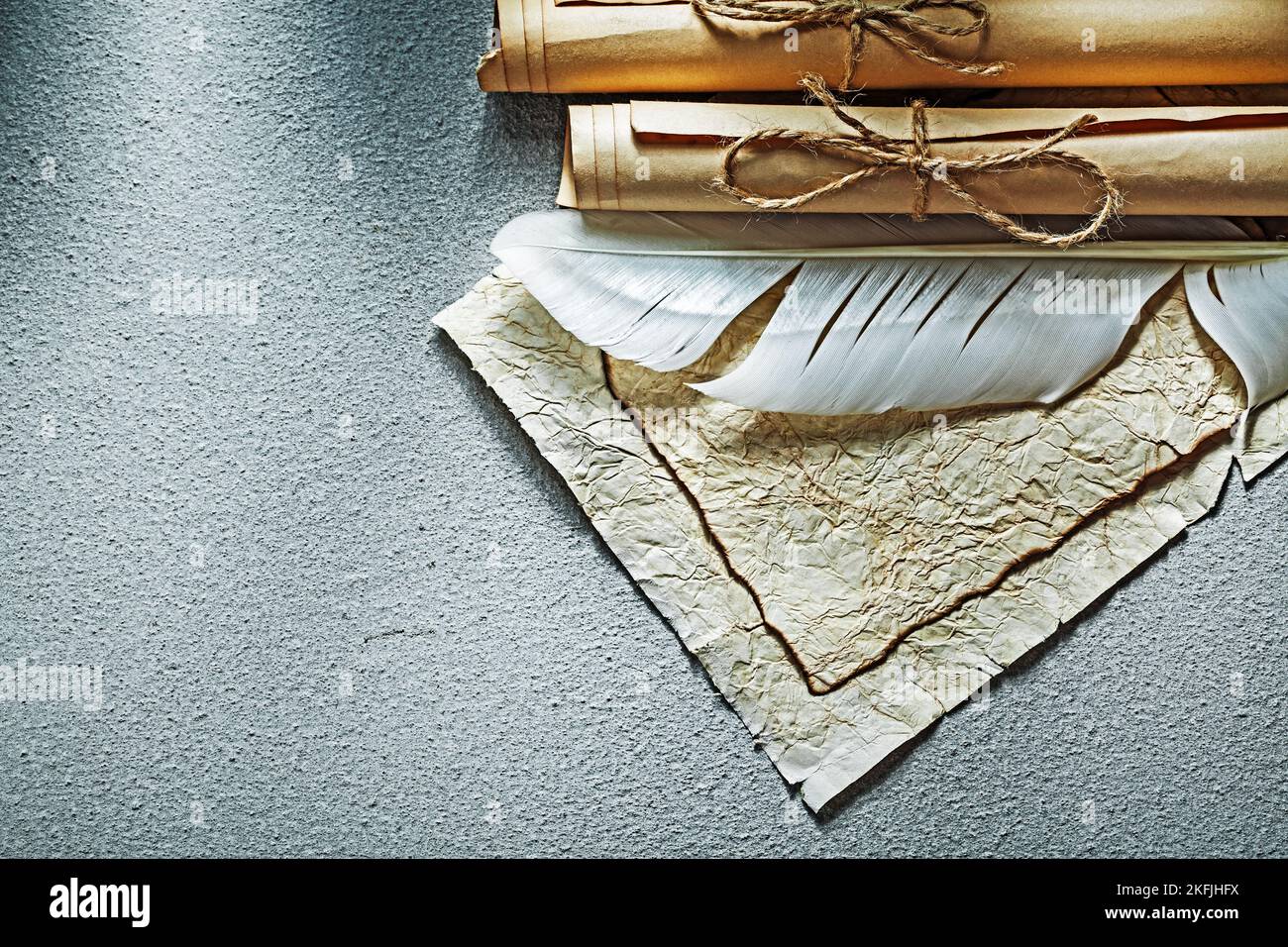 Vintage paper rolls plume on grey background Stock Photo - Alamy