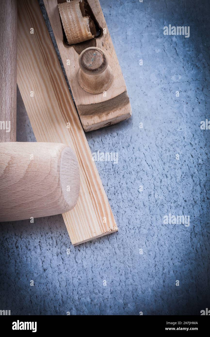 Wooden shaving plane mallet stud on metallic background construction ...