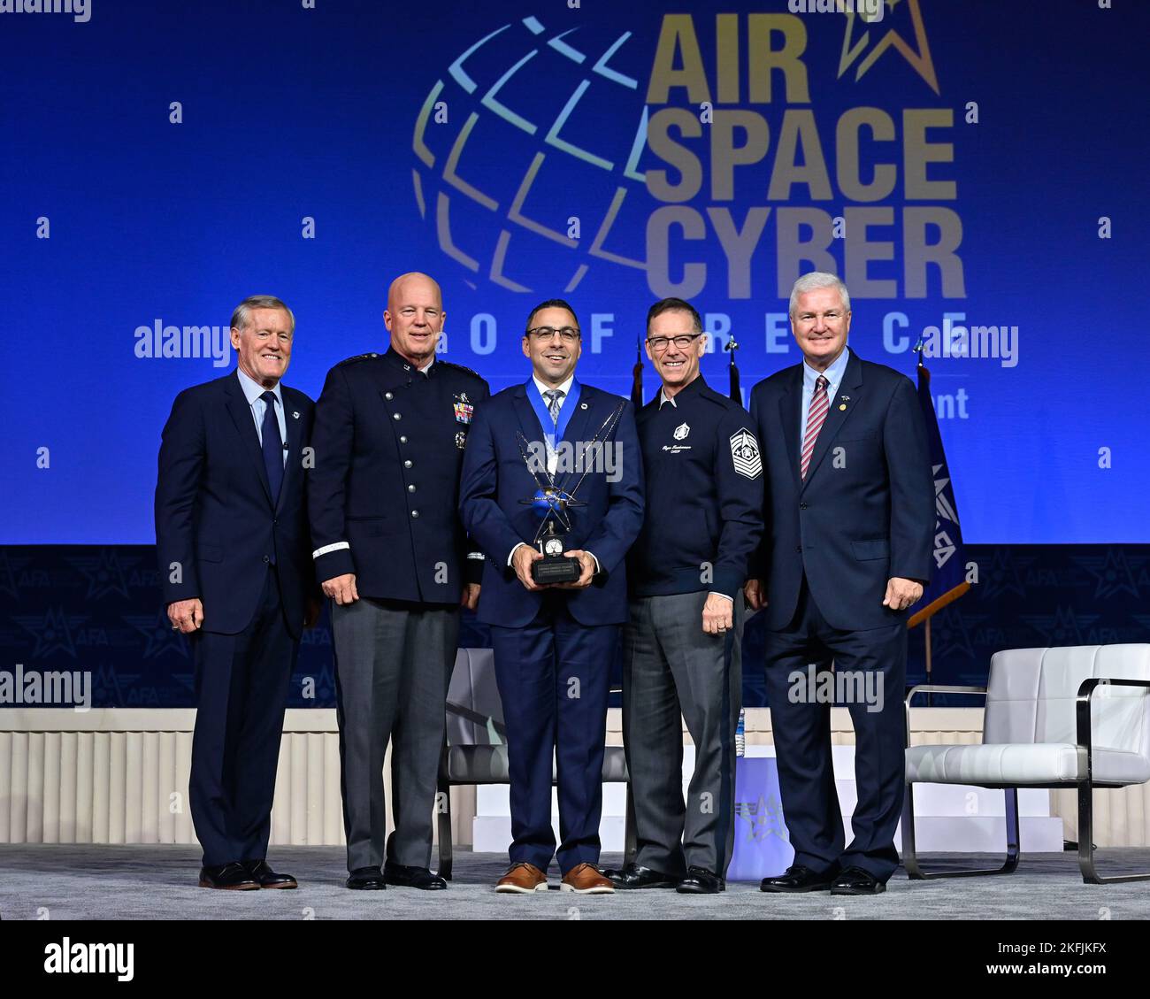 Retired Space Force Lt. Gen. William Liquori, center, poses after being ...