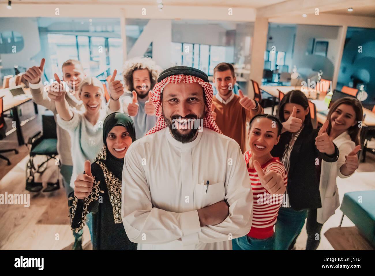 A diverse group of successful business people in a modern glass office ...