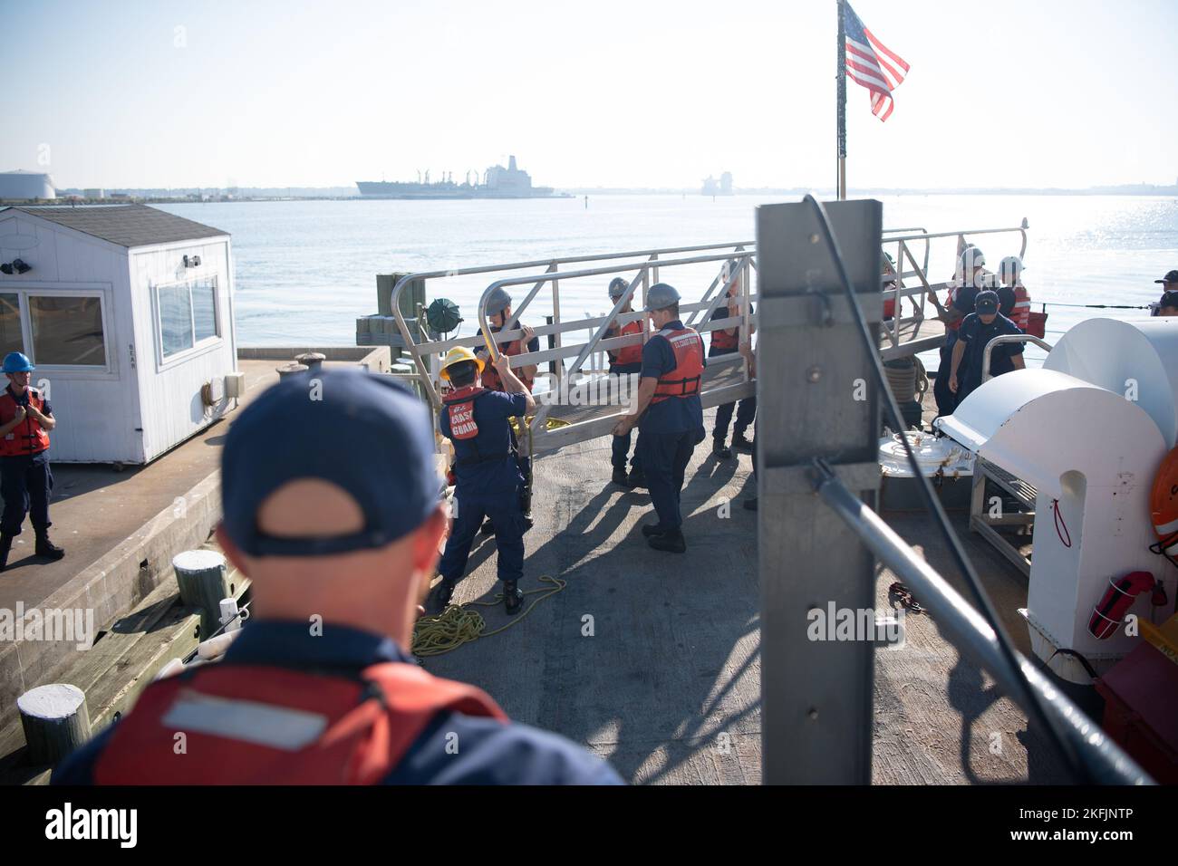Crew members aboard USCGC Bear (WMEC 901) move the brow as the Bear ...