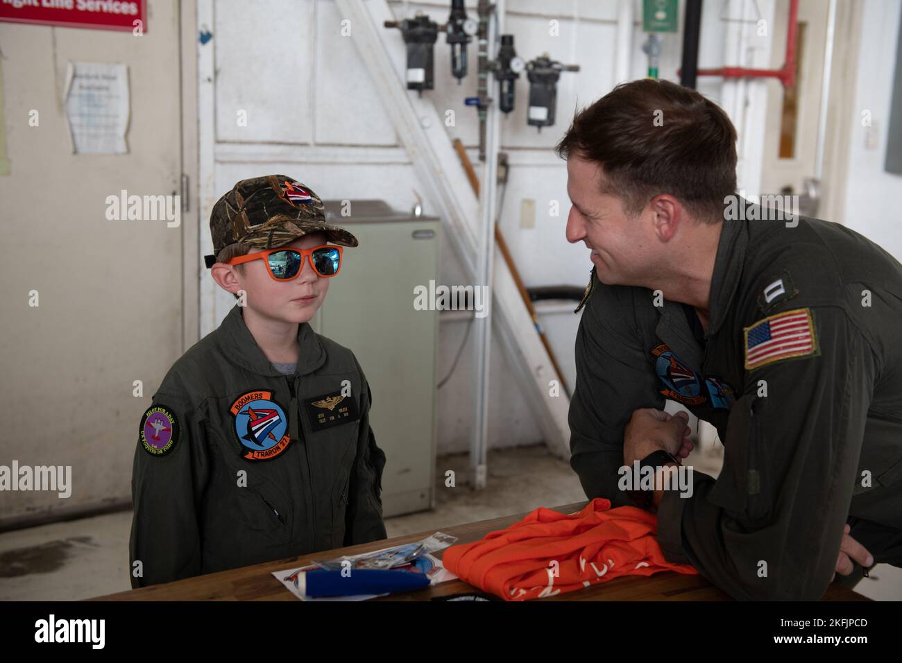 Lieutenant James Lowe gives Seth Wilkey, Pilot for a Day, VT-27 gear in ...