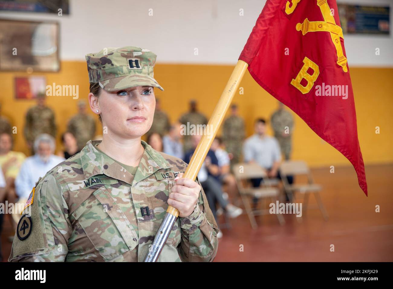 U.S. Army Capt. Jennifer Wain holds the guidon at a change of command ...