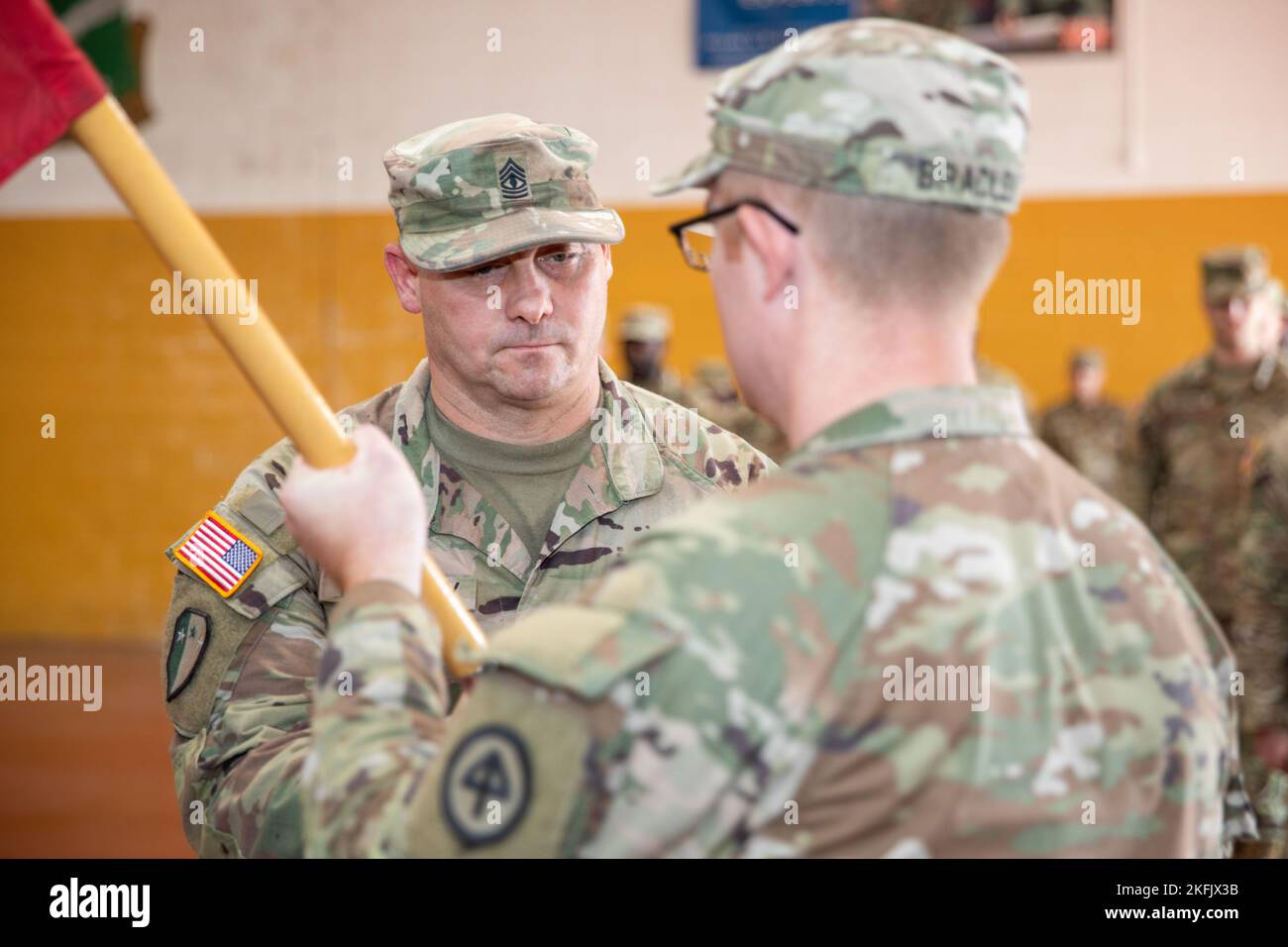 U.S. Army 1st Sgt. Christopher Mahoney passes the guidon to outgoing ...