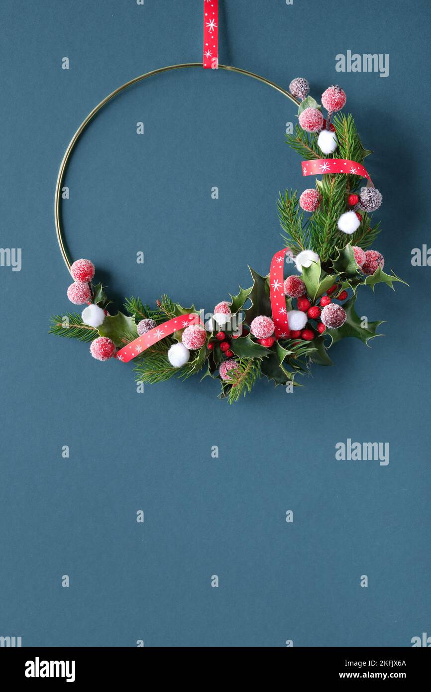 Christmas wreath with holly, fir twigs and frosted red berries. Flat ...