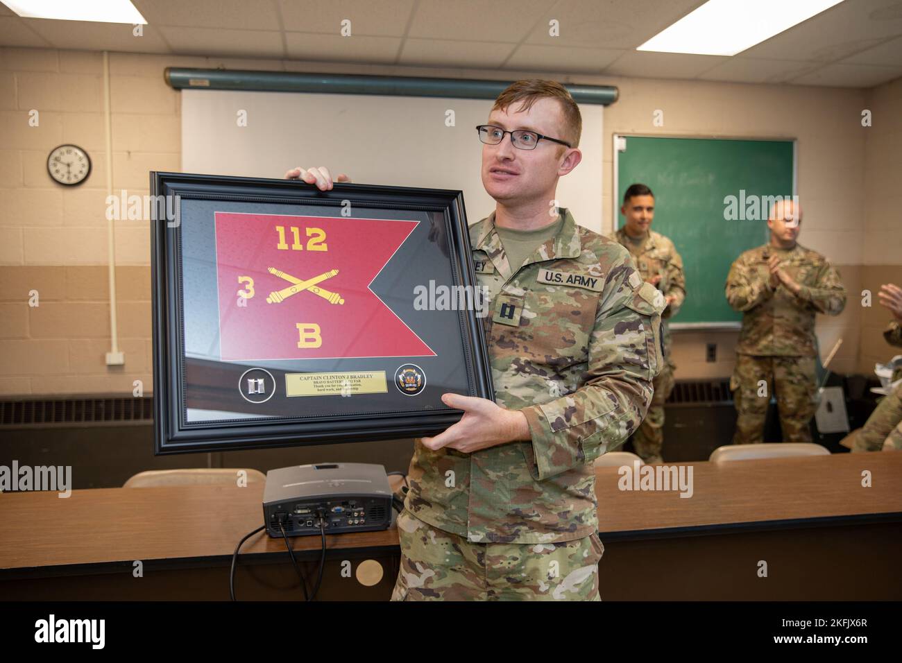 U.S. Army Capt. Clinton Bradley is given a plaque at a change of ...