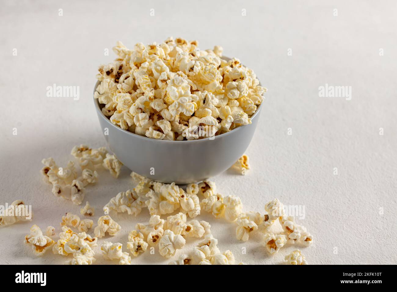 A bowl of delicious popcorn on a light background, natural delicious ...