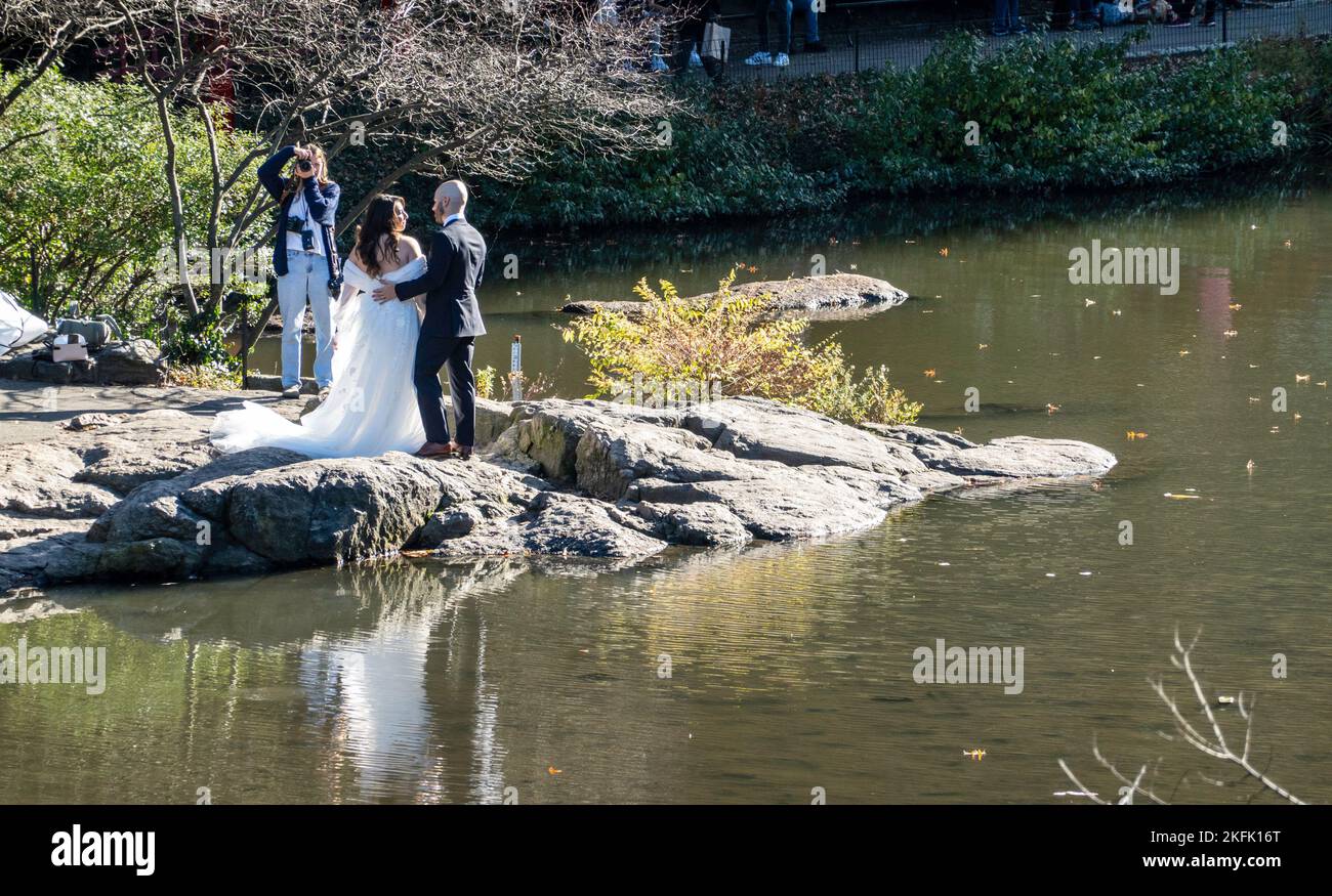 Bride and groom posed for photographs at the pond in Central Park on an ...