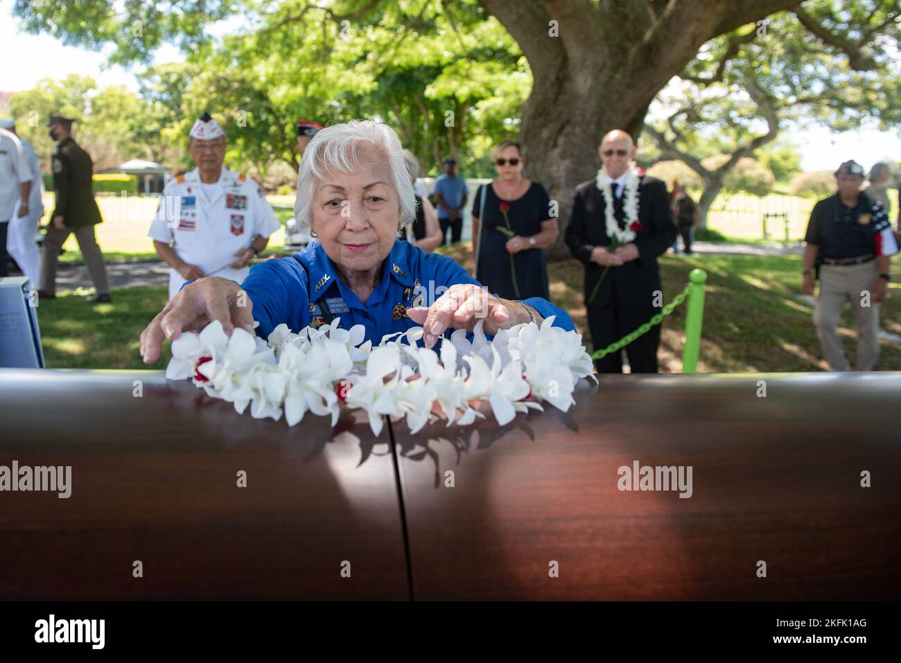 A visitor places a lei on the casket during an interment ceremony held ...