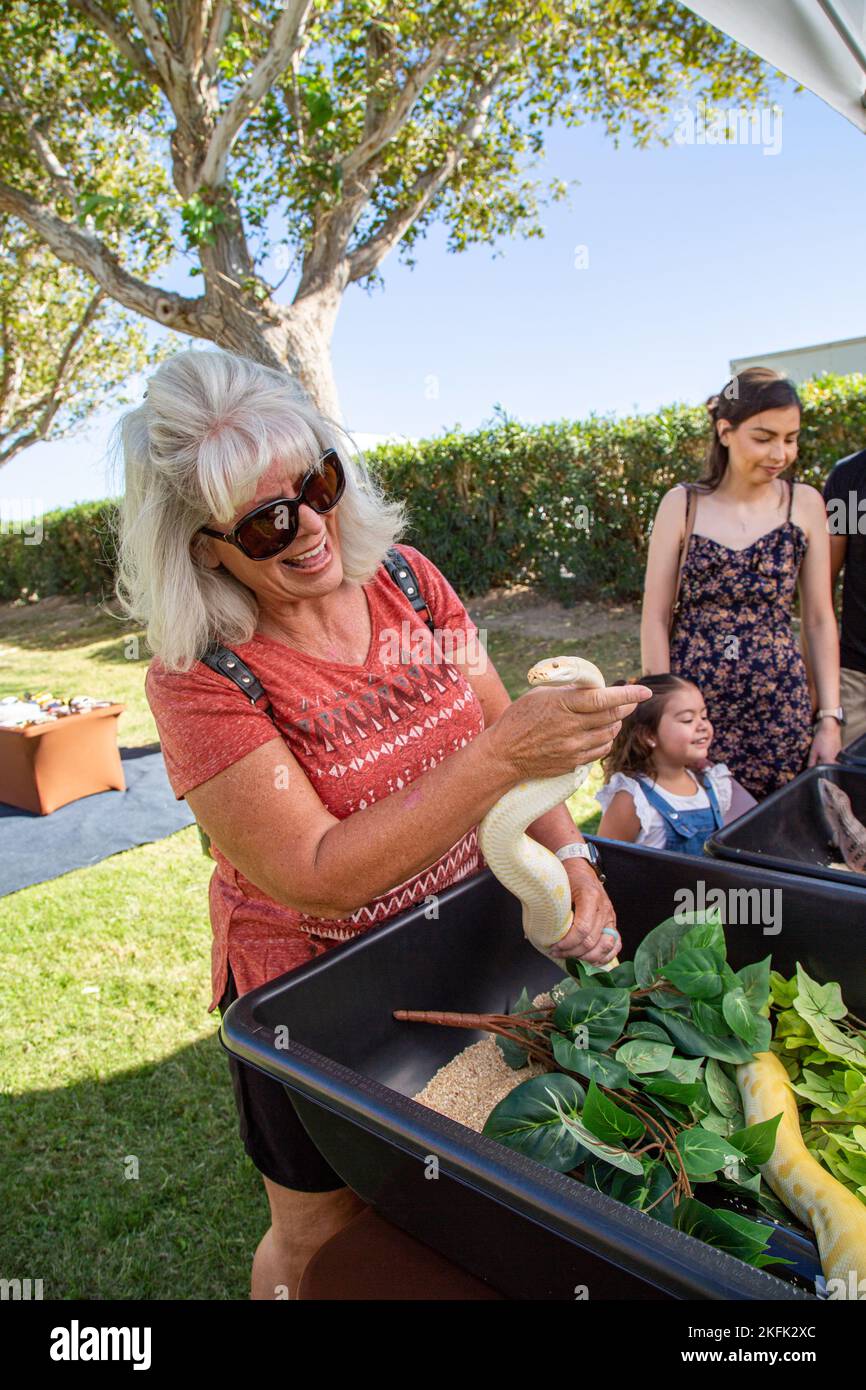 Julia Kretschmer bonds with a reticulated python at the reptile exhibit ...