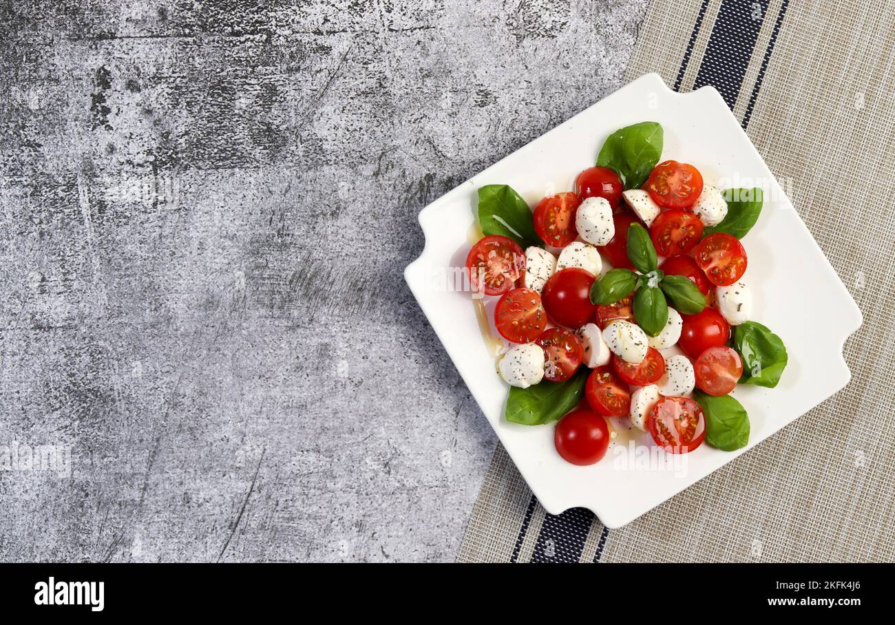 Italian caprese salad with sliced tomatoes, mozzarella, basil, olive ...