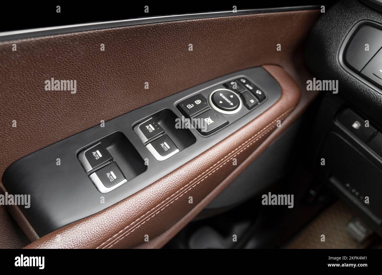 Door handle with power window control buttons of a luxury passenger car ...