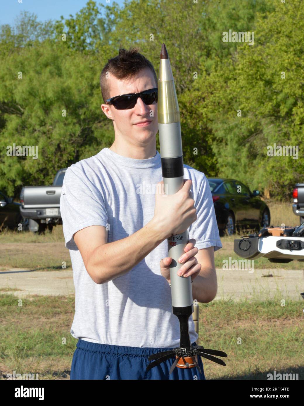 1st Lt James Brahm, Air Combat Command, studies a rocket with motor and ...