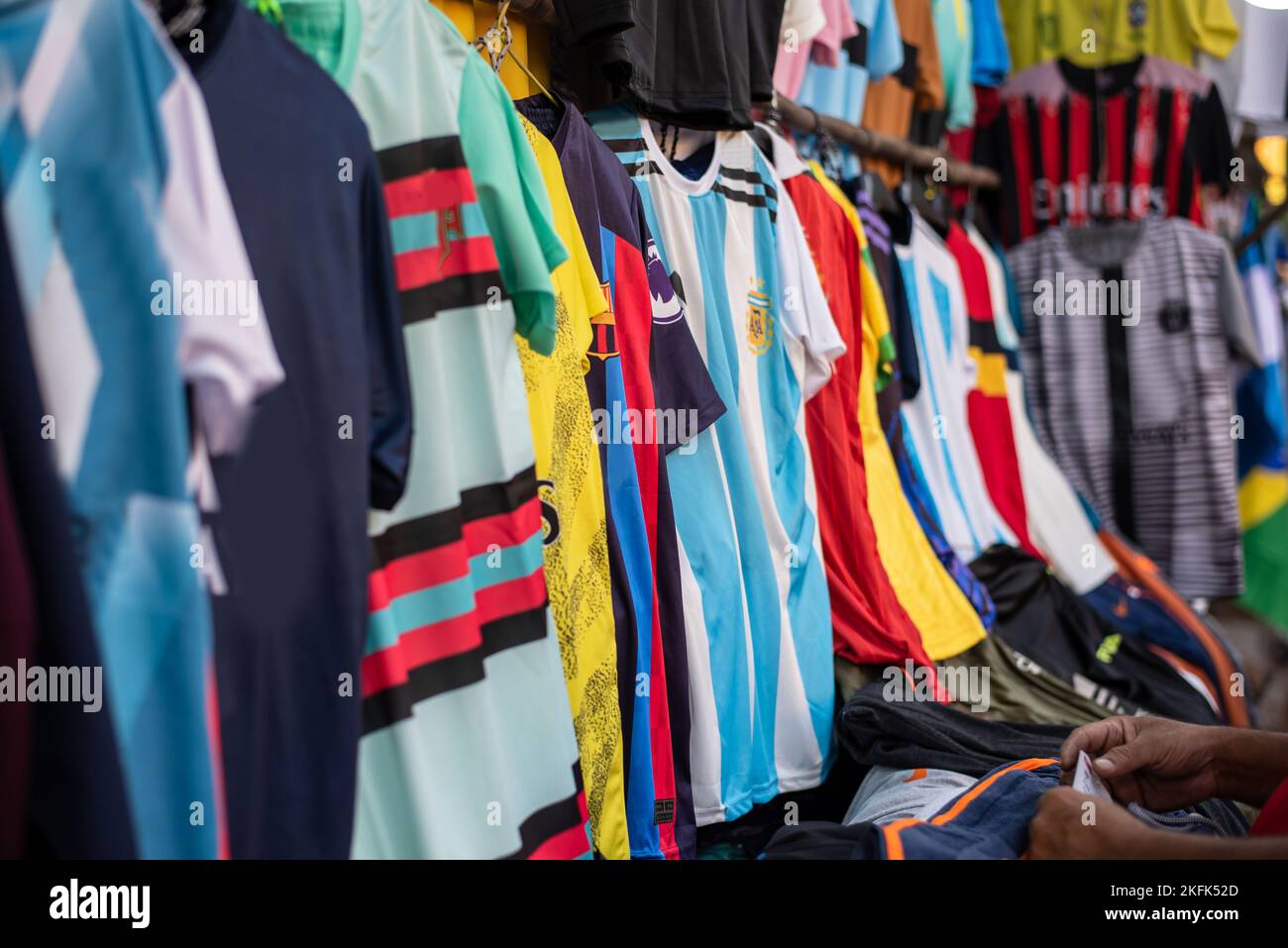soccer jerseys are hanging in a row in a store Stock Photo - Alamy