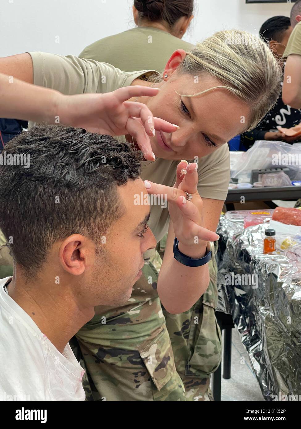 U.S. Air Force Capt. Lydia Hoover applies moulage to members of the ...