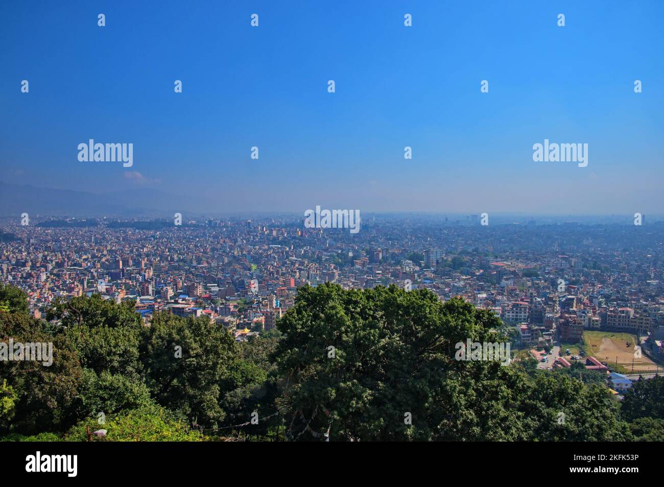 Panoramic view of the Kathmandu in Nepal through the tree branches ...