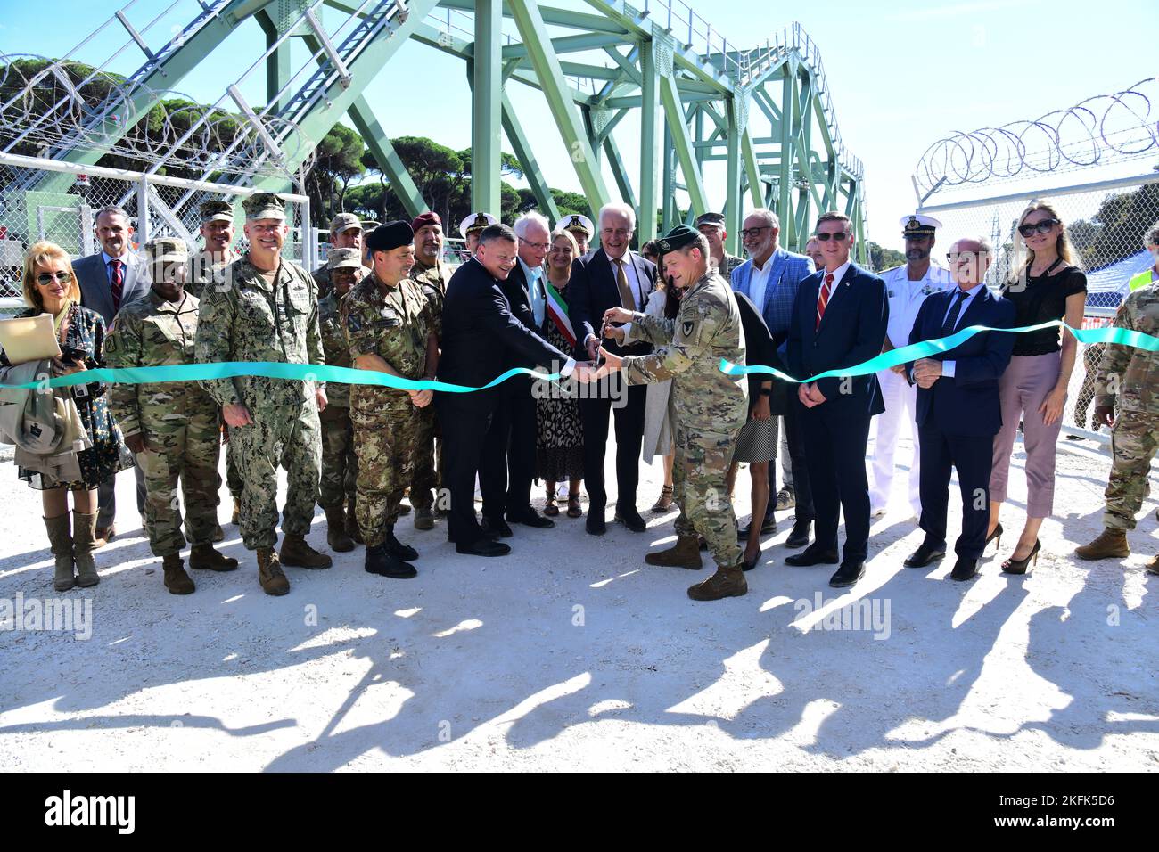 Center, the ribbon cutting is performed, from right to left, U.S. Army ...