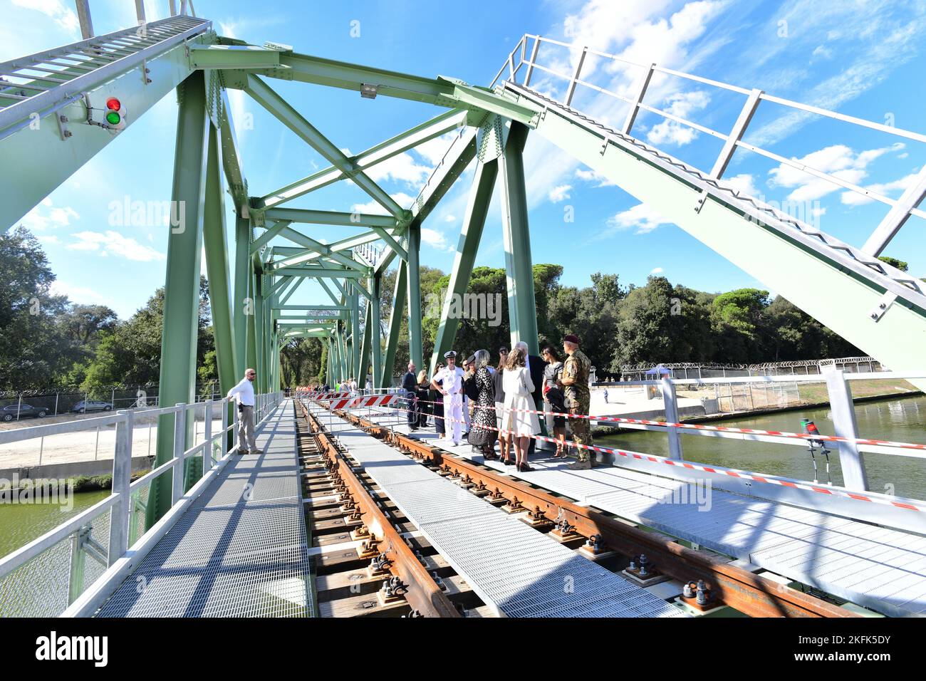 The guests cross the revolving bridge, after the ribbon cutting ...