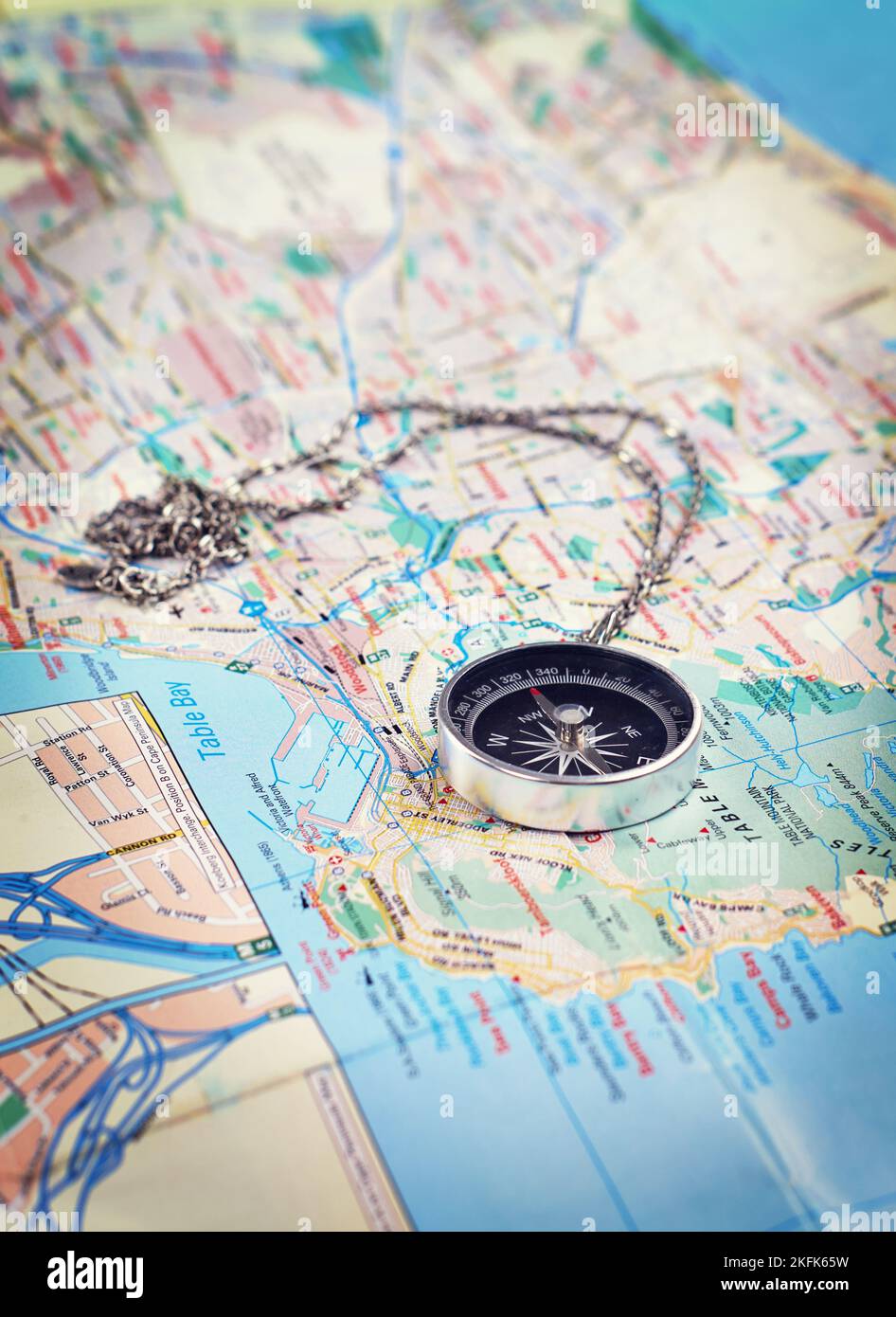 Time to explore a new city. Closeup shot of a city map with a compass ...