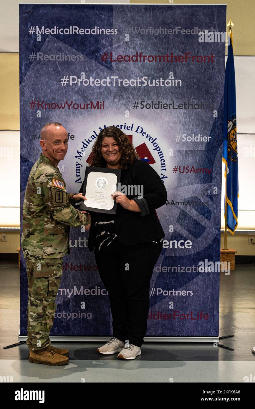 Col. Andy Nuce presents Erica Smith a 20 year Service Award certificate ...