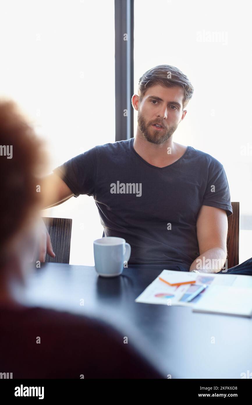 Getting feedback on progress. two colleagues having a discussion in the ...