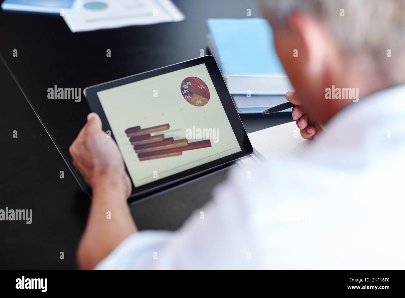 Auditing made easier with technology. a businessman looking at graphs ...