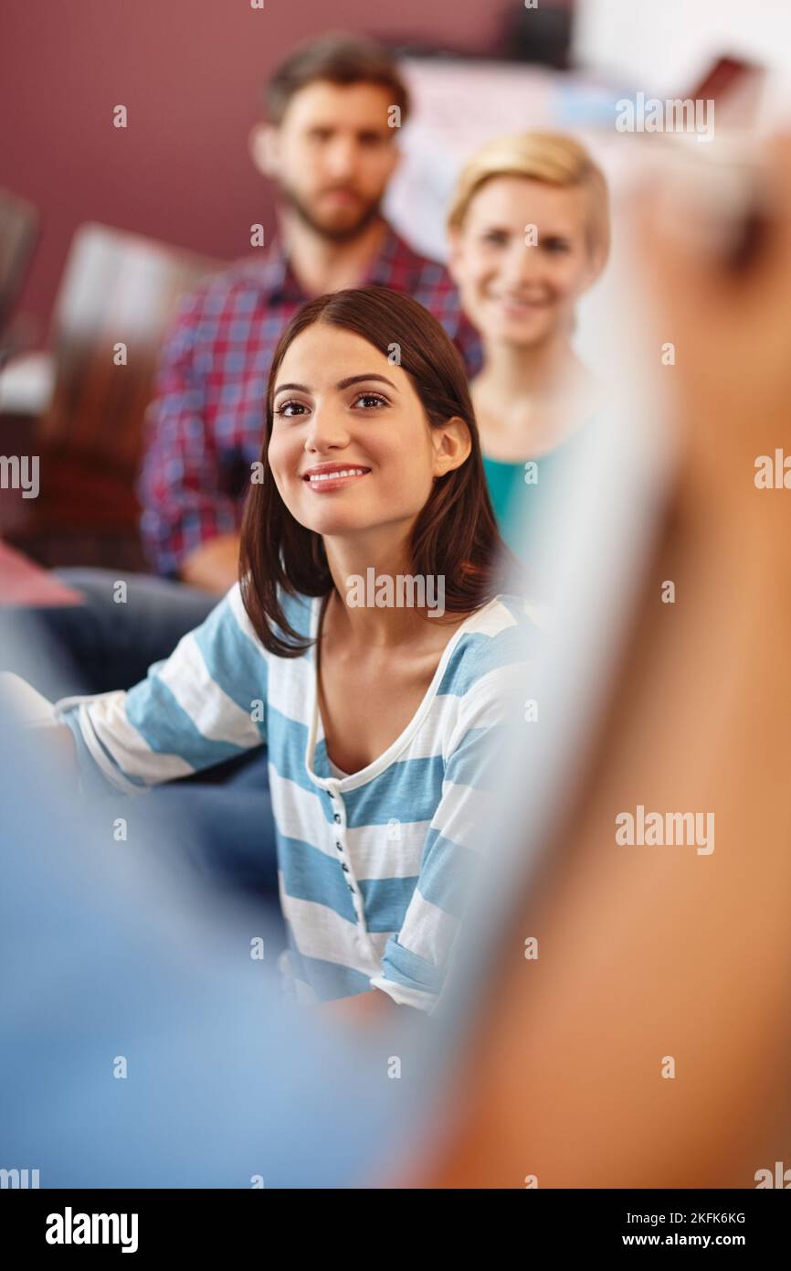 Stay focused. a group of coworkers listening to a presentation Stock ...