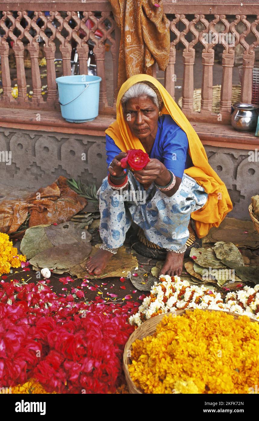 Woman vendor selling marigold garlands in Jaipur, Rajasthan, India ...